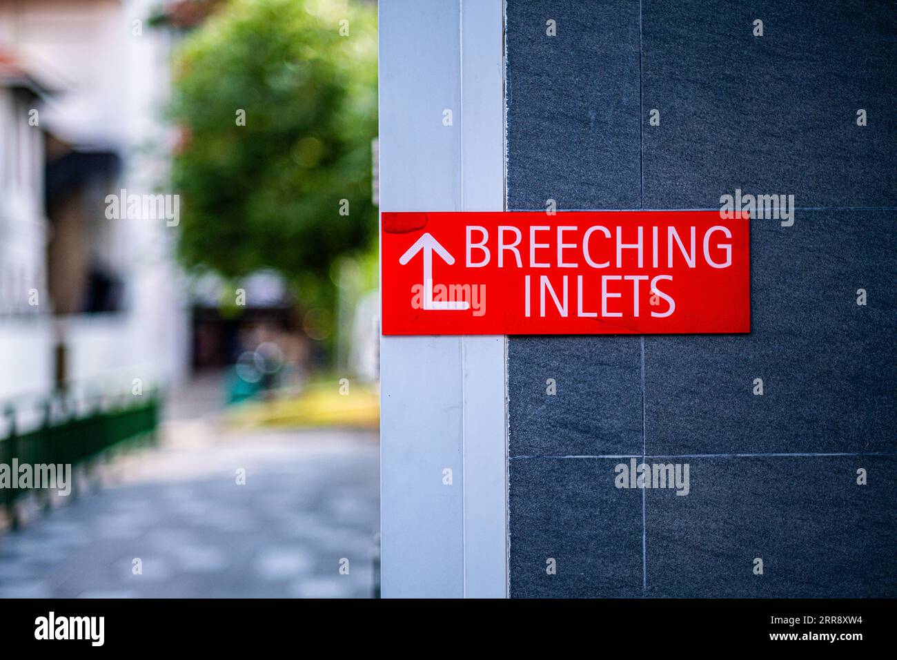 'BREECHING INLET' sign on red plate on concrete wall in Singapore ...
