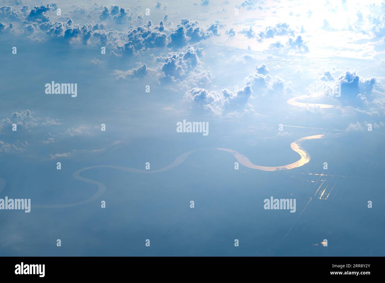 Blue sky view from aircraft airplane and white clouds and shiny river ...