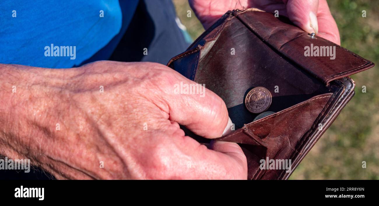 Poverty in old age Pensions looks into his wallet Stock Photo - Alamy