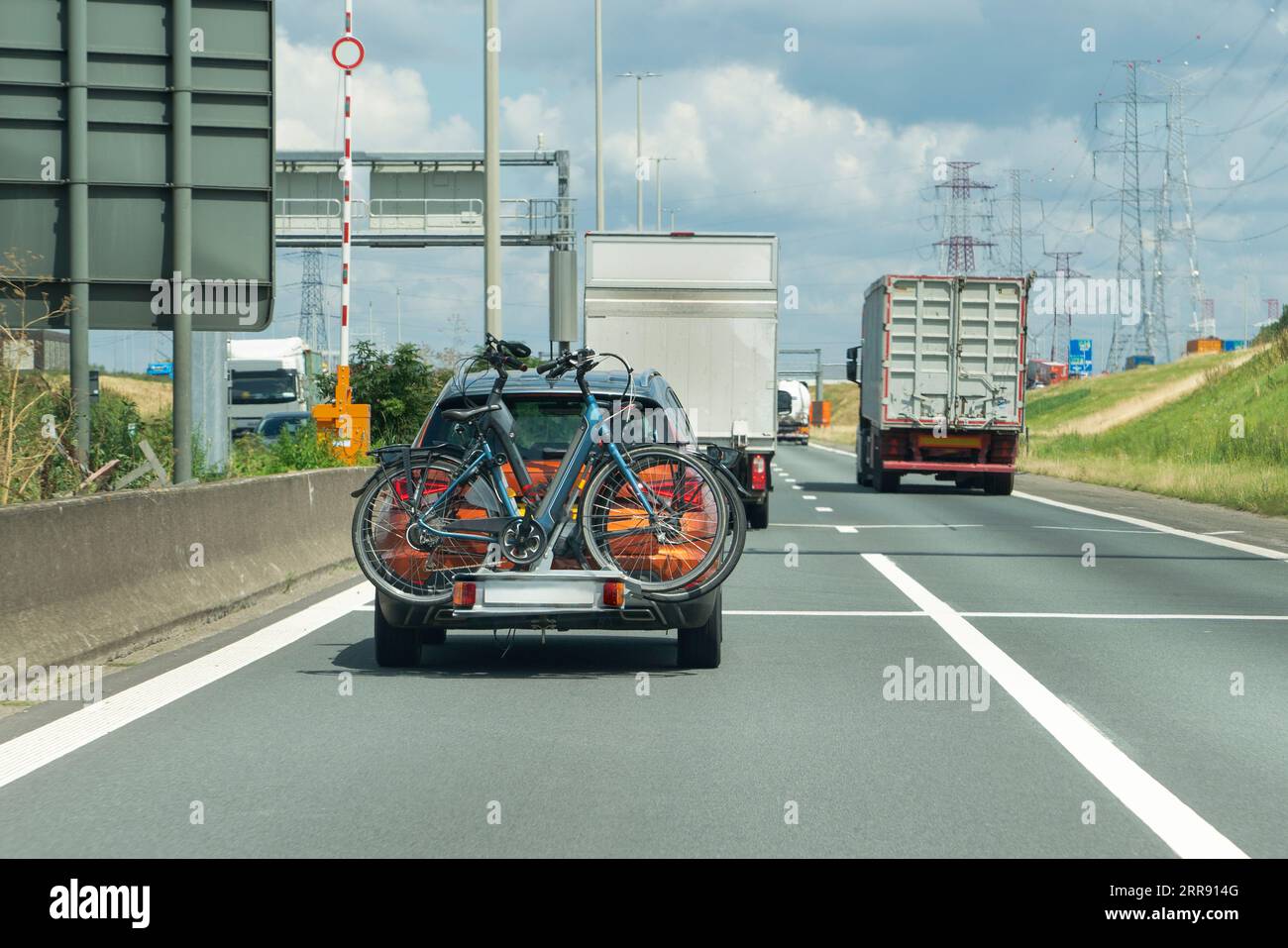 Car transports bicycles on a rack on highway Stock Photo - Alamy