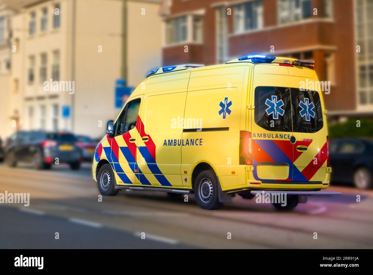 Closeup view of yellow colored emergency ambulance car in the street ...