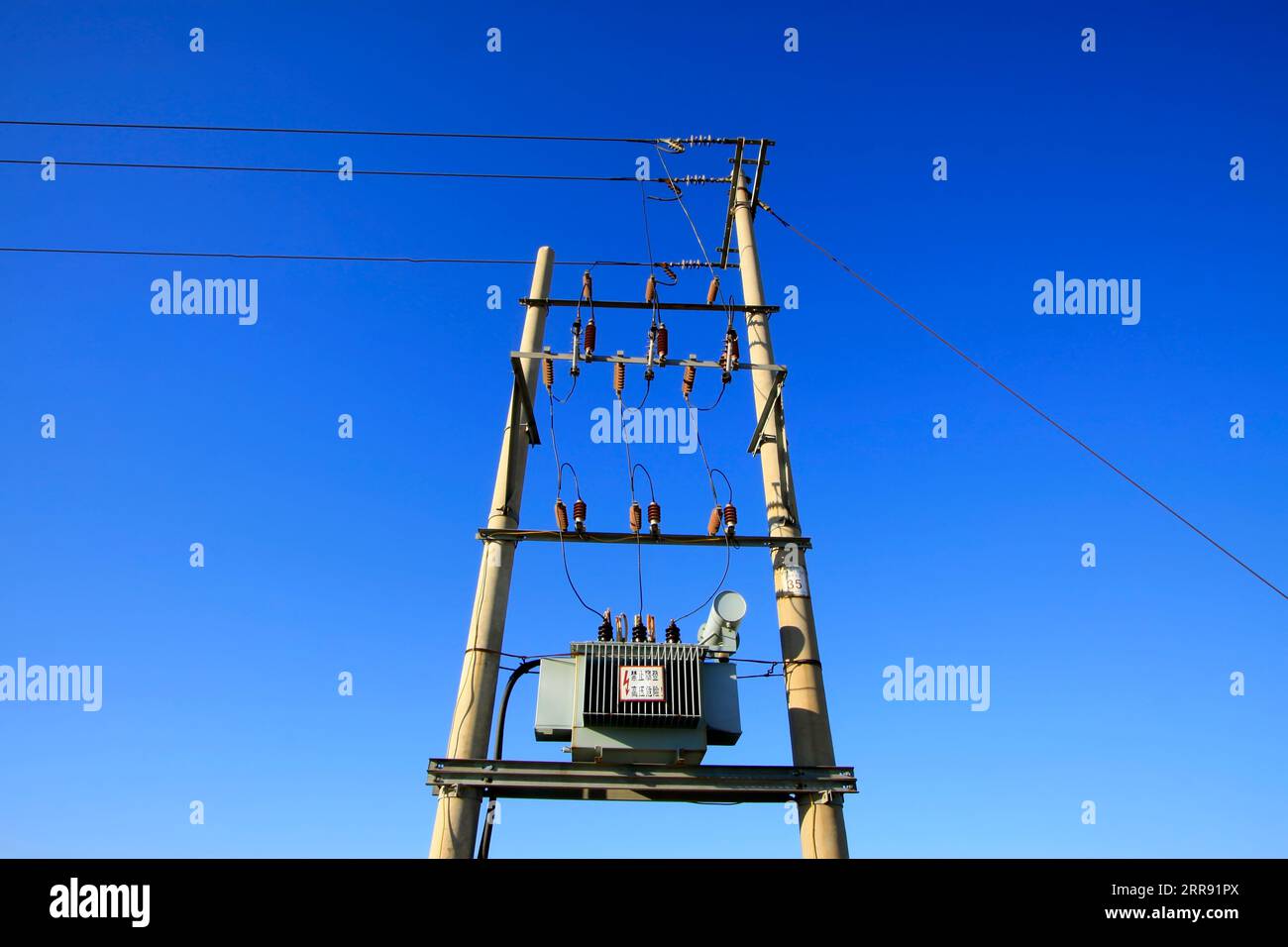 Transformer and pole under the blue sky, closeup of photo Stock Photo ...
