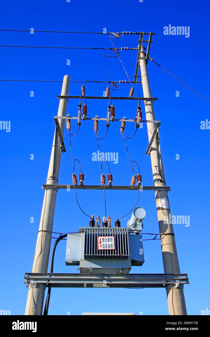 Transformer and pole under the blue sky, closeup of photo Stock Photo ...