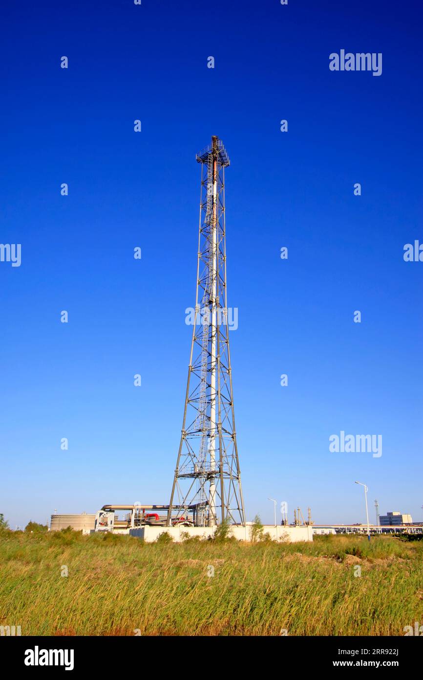 Oil pipe tower under blue sky, closeup of photo Stock Photo - Alamy