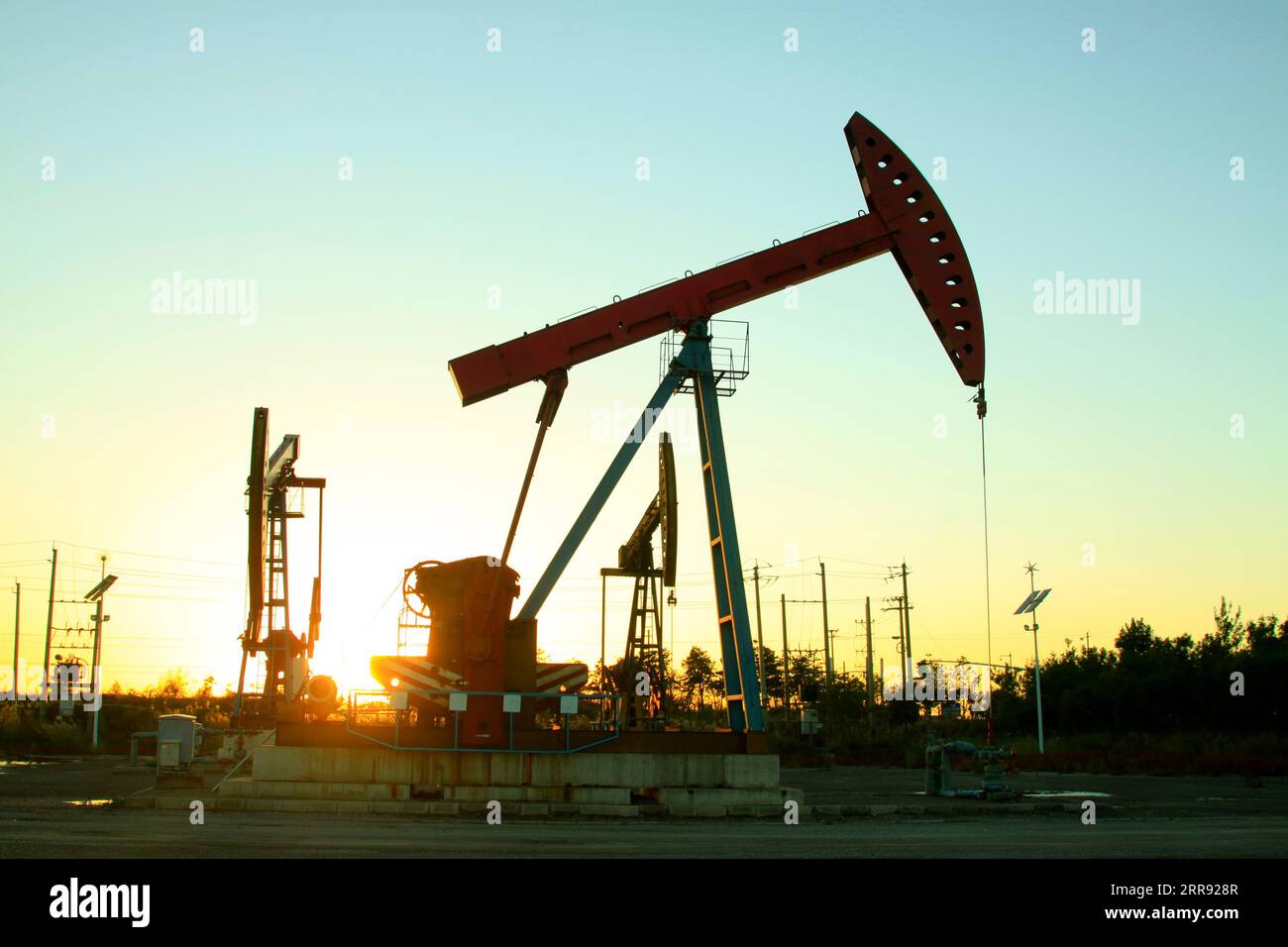 Crank balanced beam pumping unit in the oil field, closeup of photo ...