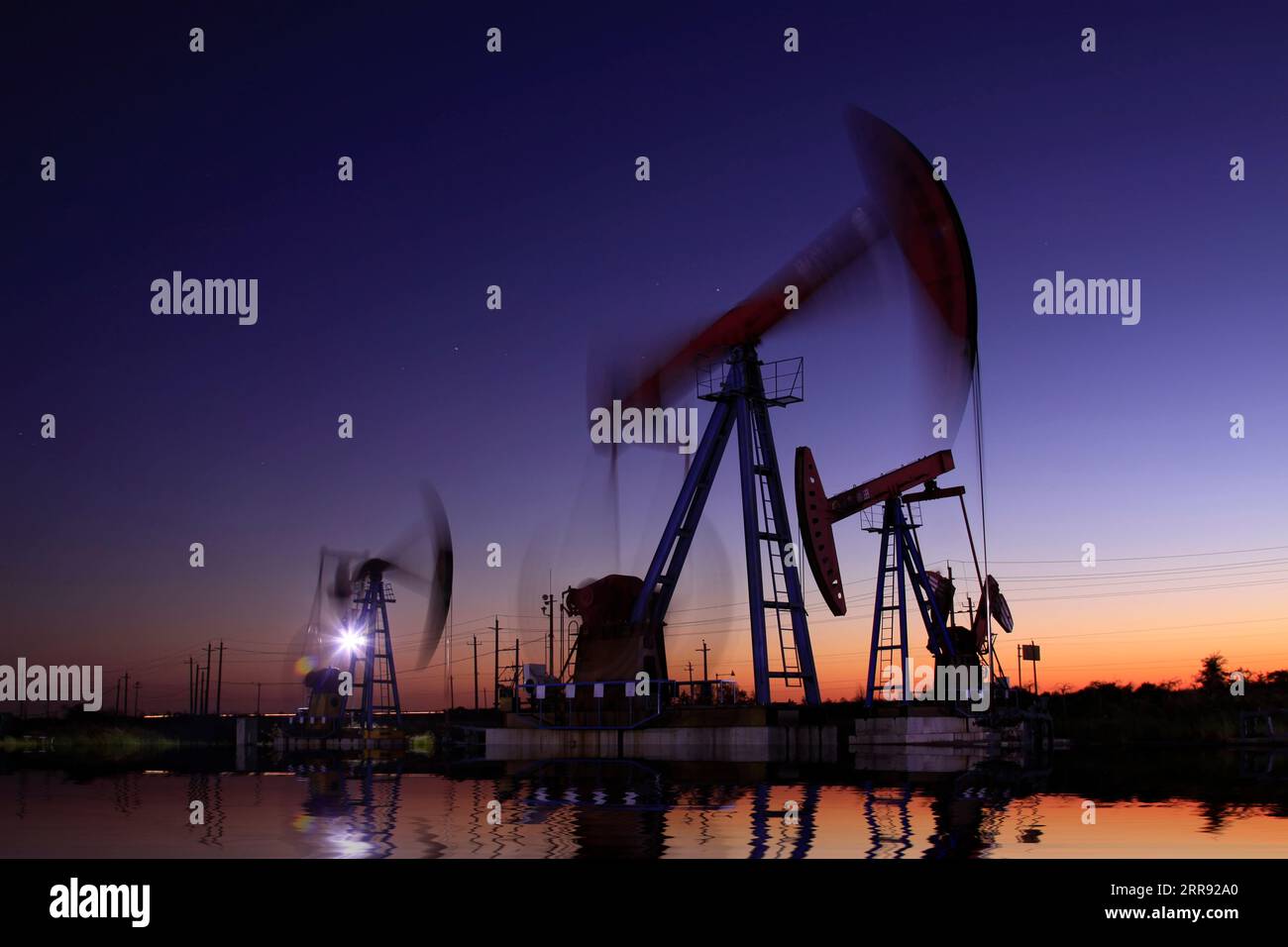 Crank balanced beam pumping unit in the oil field, closeup of photo ...