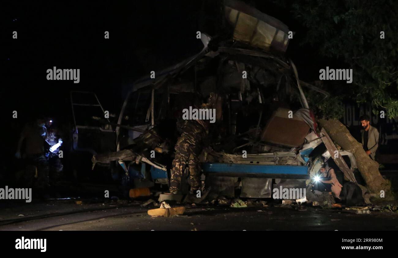 210601 -- KABUL, June 1, 2021 -- Security personnel inspect a damaged ...