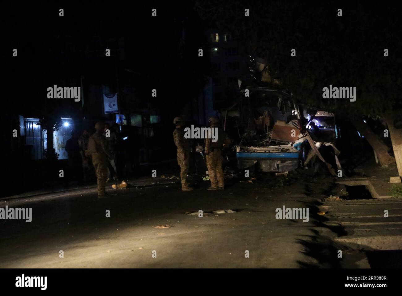 210601 -- KABUL, June 1, 2021 -- Security personnel inspect a damaged ...