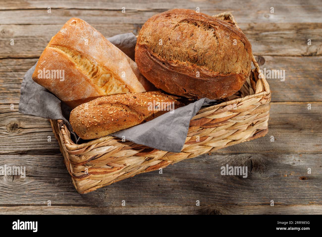 Assorted bread varieties in a charming basket, ready to be enjoyed ...