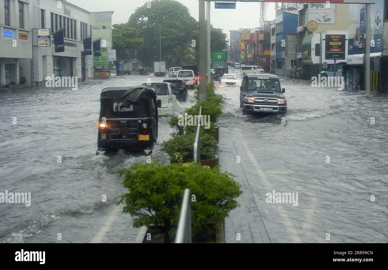 210603 -- COLOMBO, June 3, 2021 -- Vehicles run on a flooded road after ...