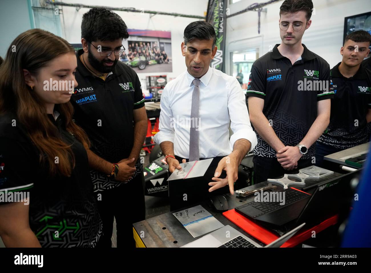 Prime Minister Rishi Sunak (centre) views the build of an electric ...