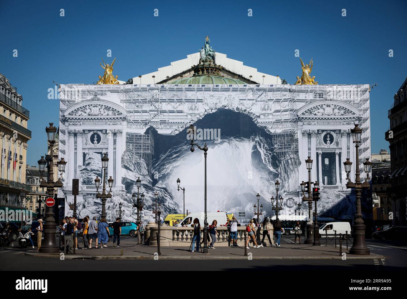 People walk by the Opera Garnier Thursday, Sept. 7, 2023 in Paris ...