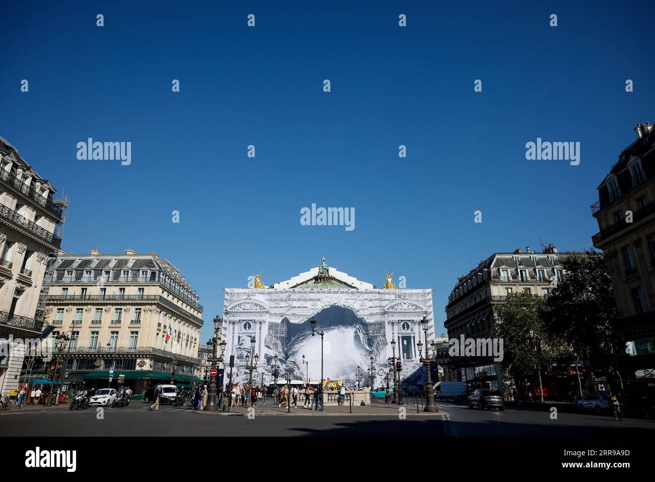 People walk by the Opera Garnier Thursday, Sept. 7, 2023 in Paris ...