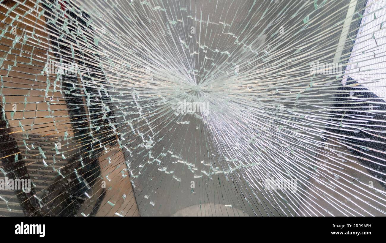 impact on the broken window glass on the commercial facade of a store ...