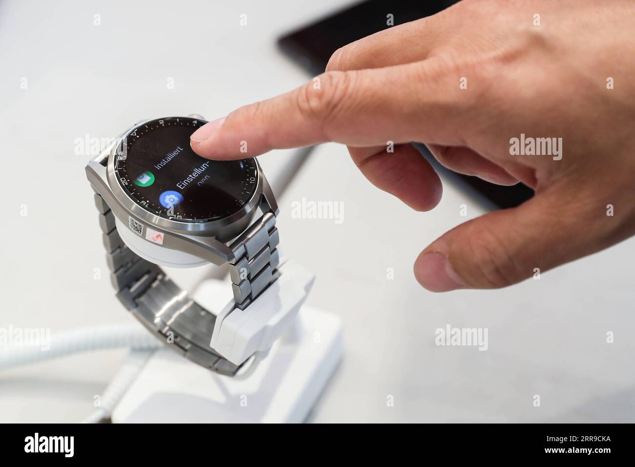 210609 -- BERLIN, June 9, 2021 -- A staff member displays a Huawei ...