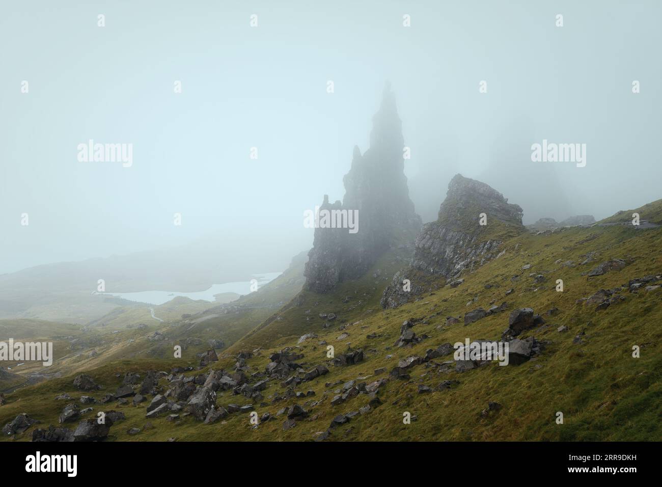 Atmospheric view of high sharp cliffs covered in fog. The Old Man of ...