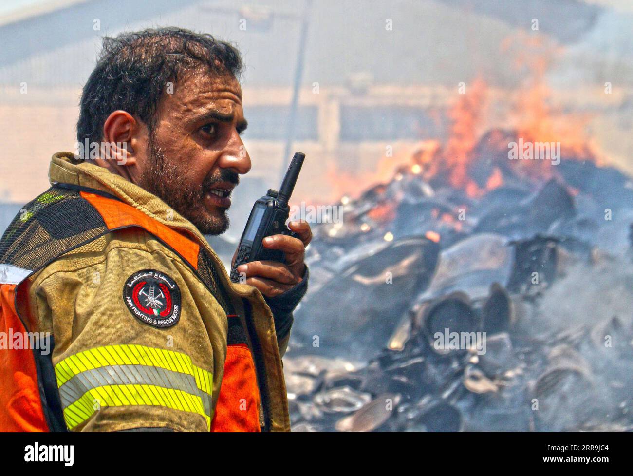 210619 -- CAPITAL GOVERNORATE, June 19, 2021 -- A firefighter works at ...