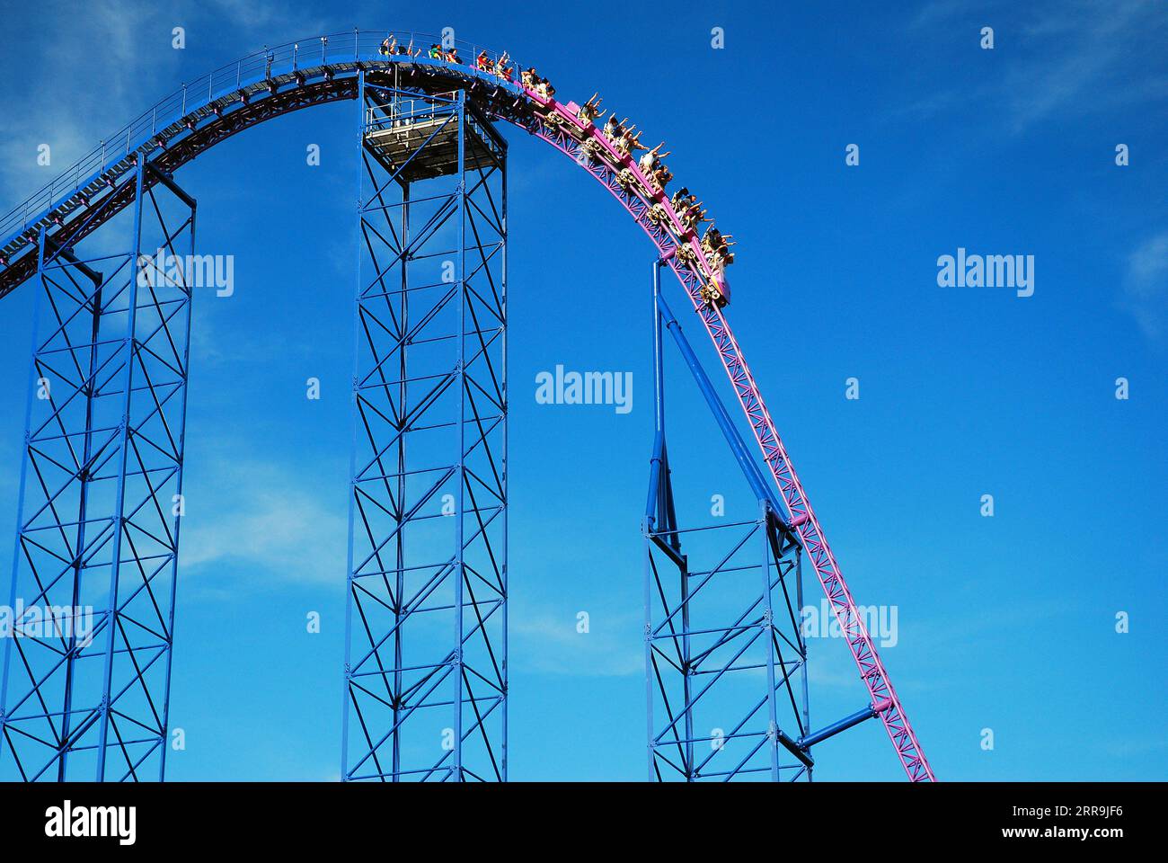Thrill seekers head into a free fall descent on a roller coaster Stock ...
