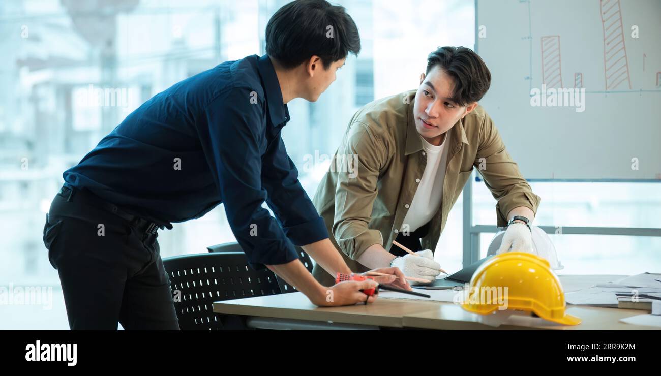 Engineer team with construction work plan discussion together blueprint ...