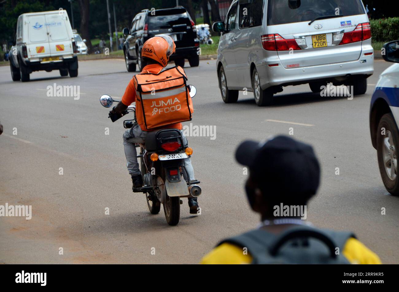 210622 -- KAMPALA, June 22, 2021 -- A delivery man delivers food to ...