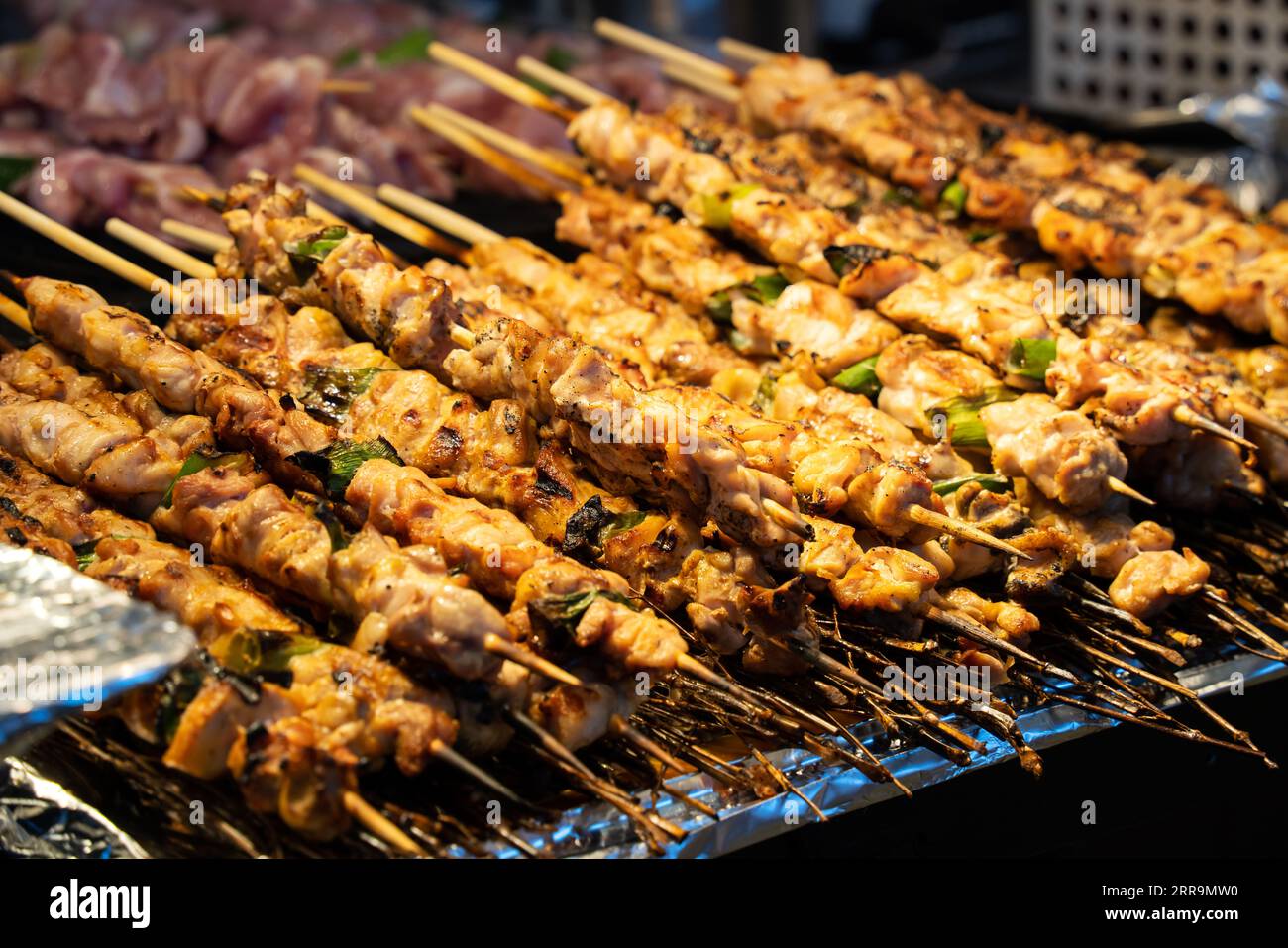 Grilling barbecue meat skewer kebab at traditional night market stall ...