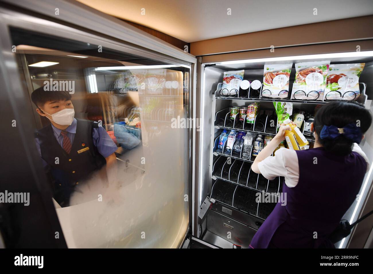 210625 -- BEIJING, June 25, 2021 -- A staff restocks a vending machine ...