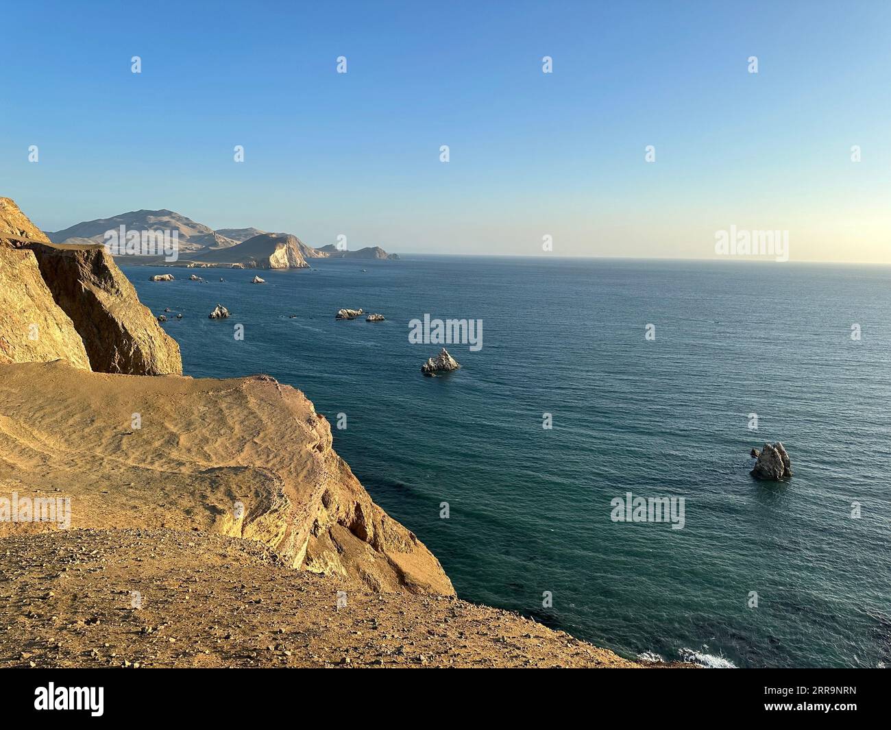 A breathtaking view of rocky cliffs against a golden sunrise backdrop ...