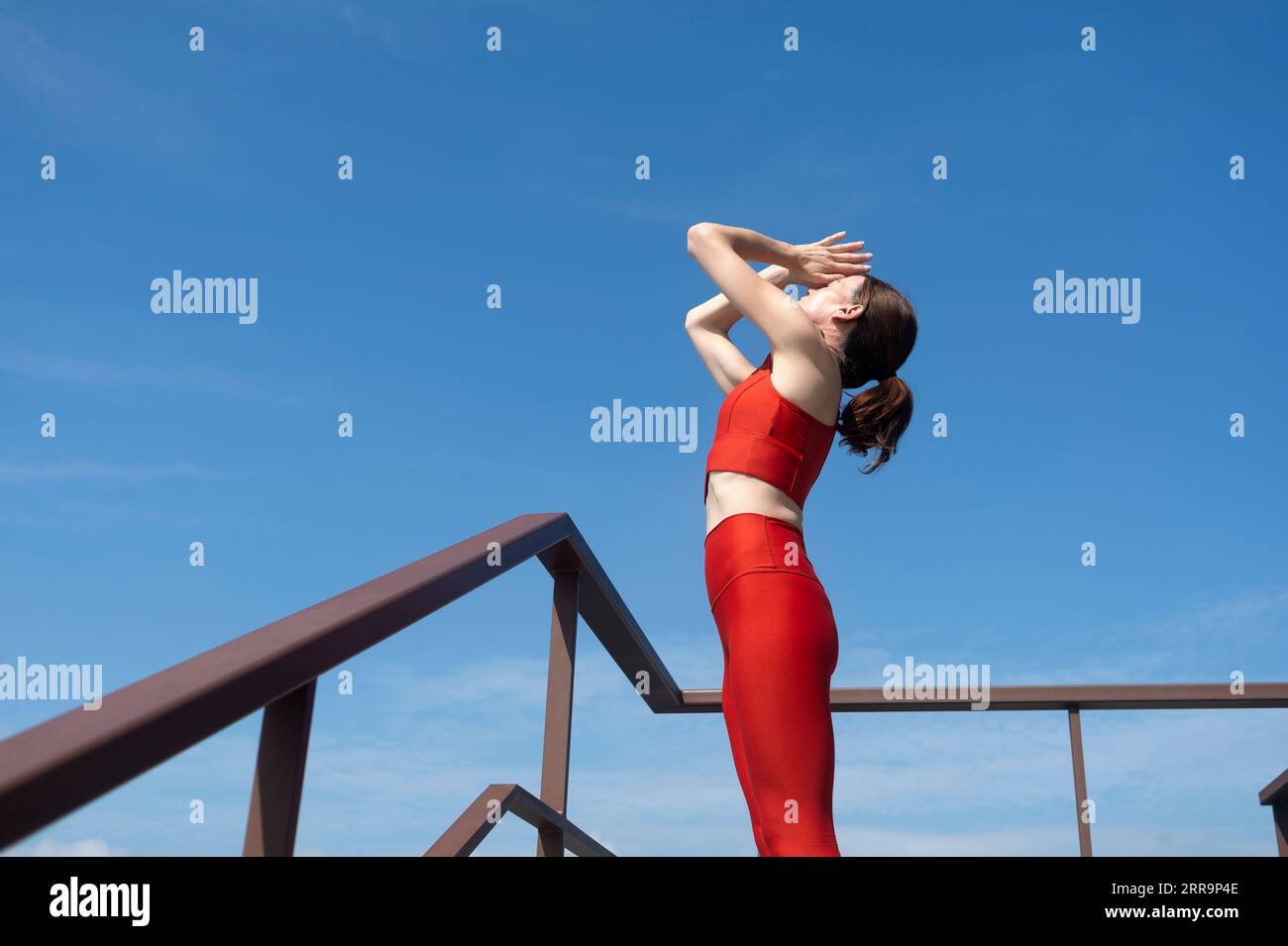 Fit, sporty woman standing and meditating outside, third eye Stock ...