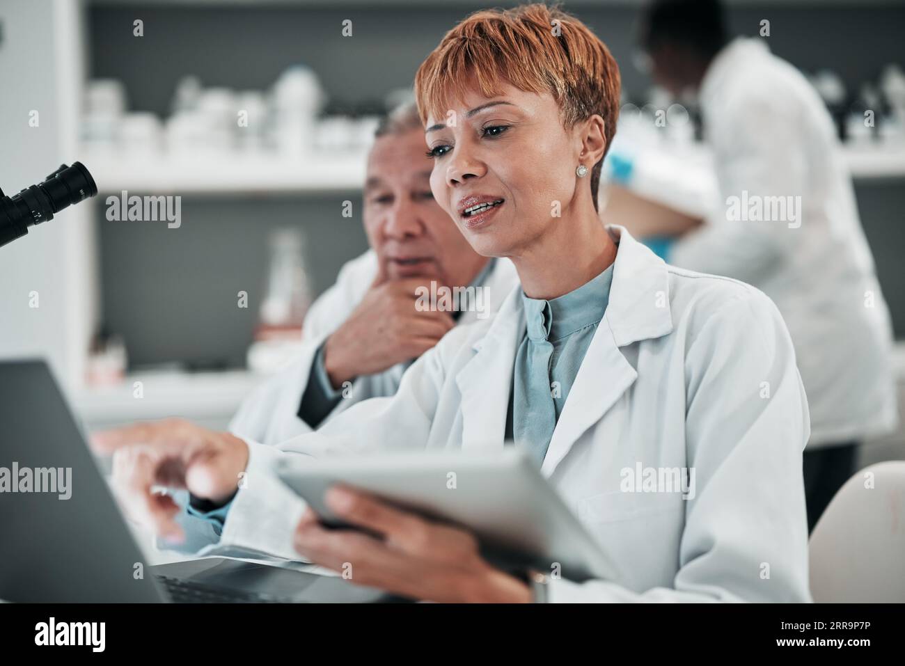 Science, teamwork and discussion on laptop in laboratory to research ...