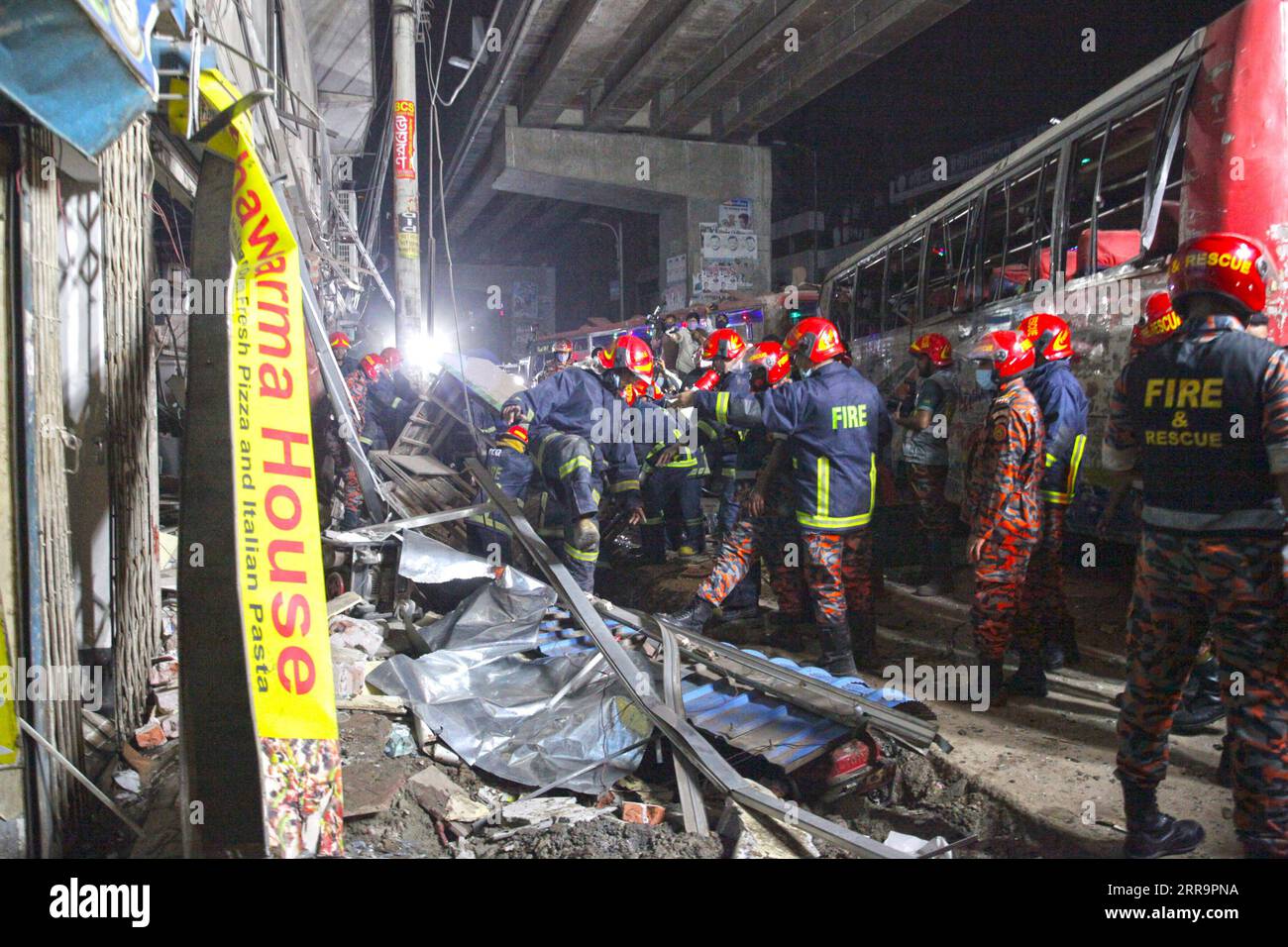 210627 -- DHAKA, June 27, 2021 -- Rescuers work at the site of an ...