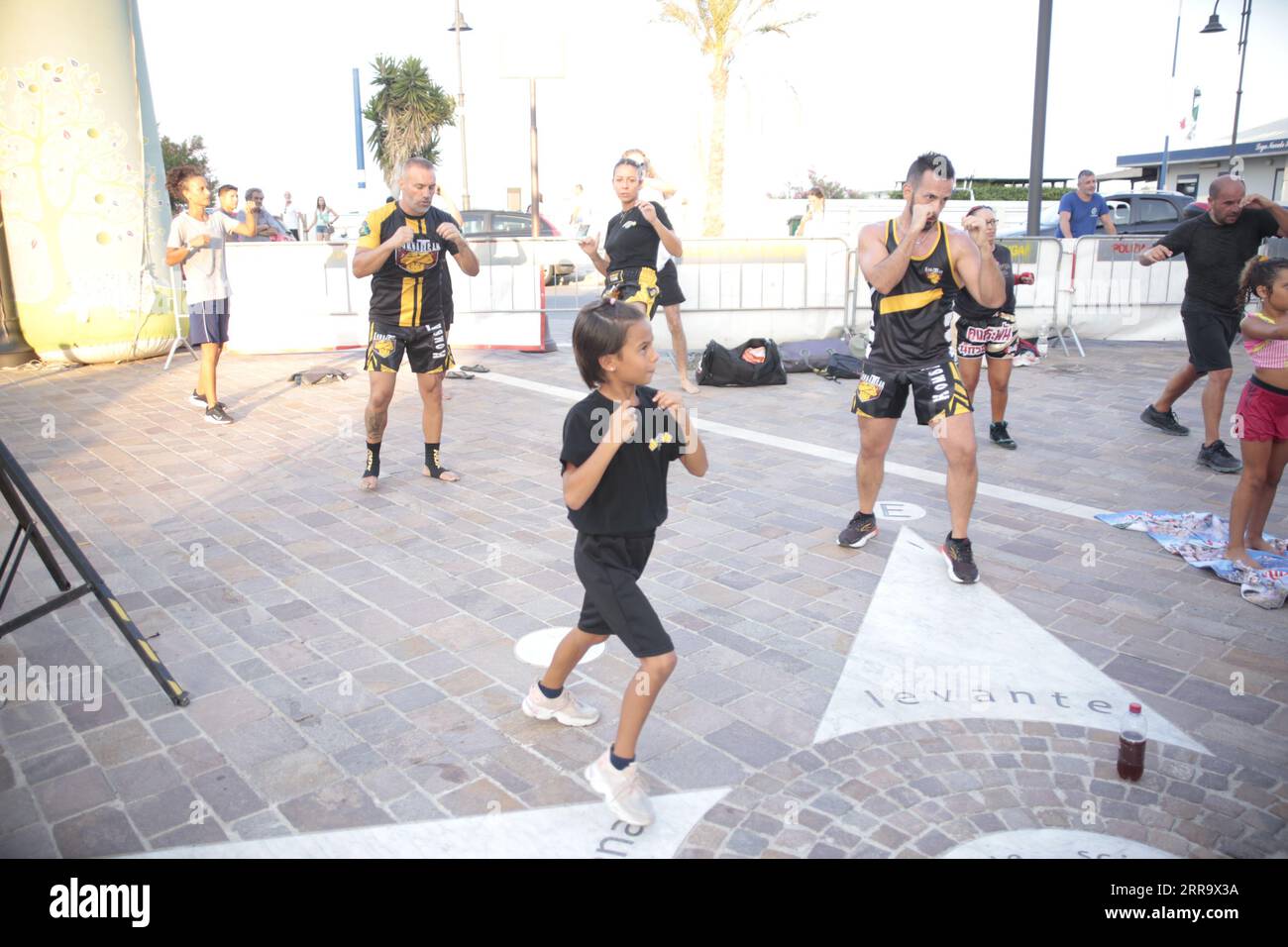 The images depict an animated children's kickboxing class in Italy at a ...