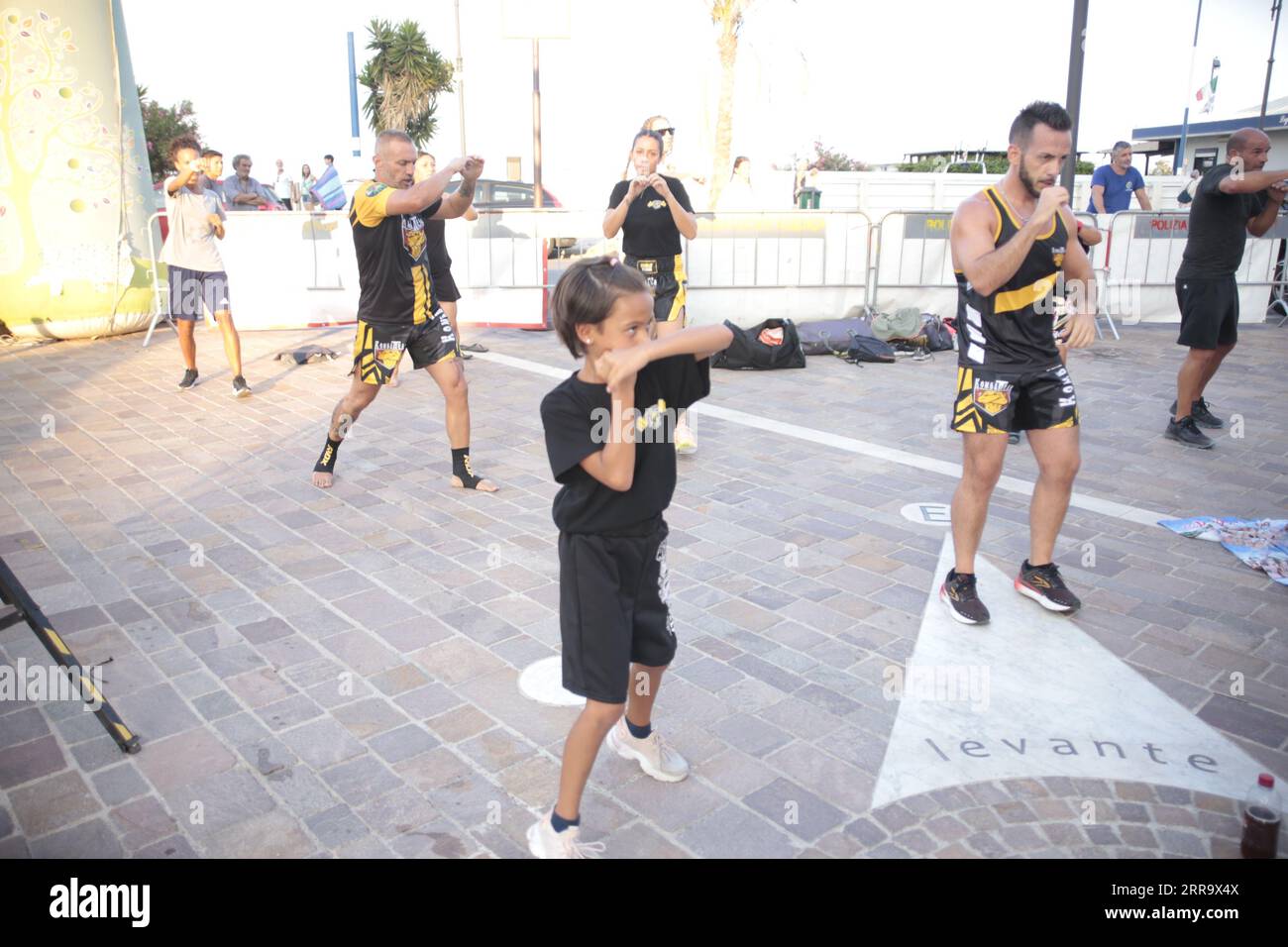 The images depict an animated children's kickboxing class in Italy at a ...