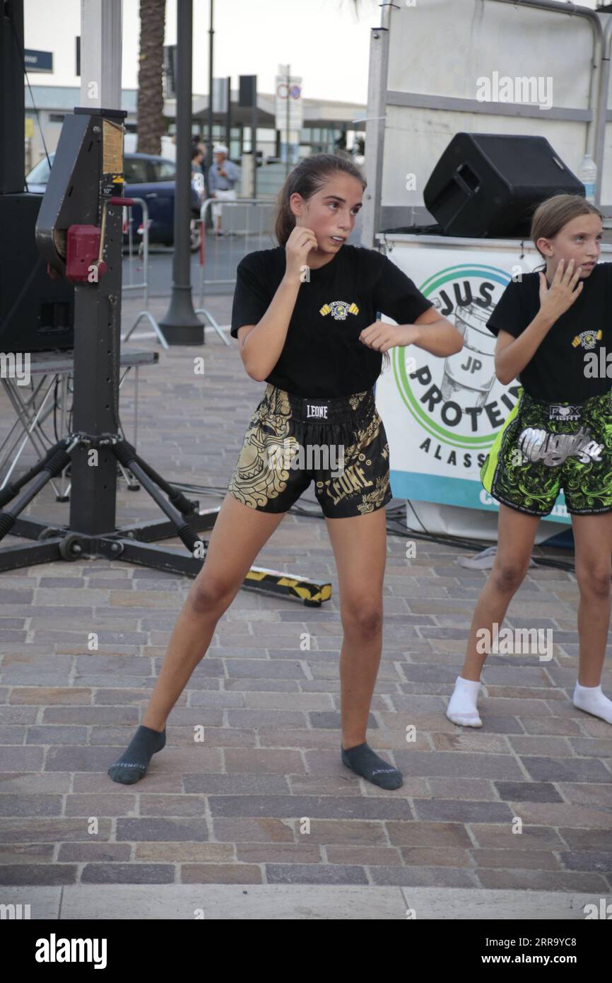 The images depict an animated children's kickboxing class in Italy at a ...