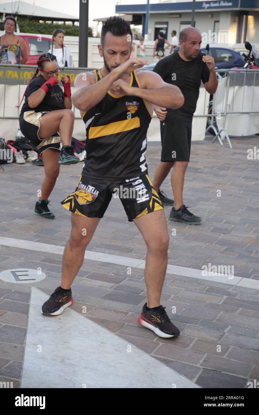 The images depict an animated children's kickboxing class in Italy at a ...