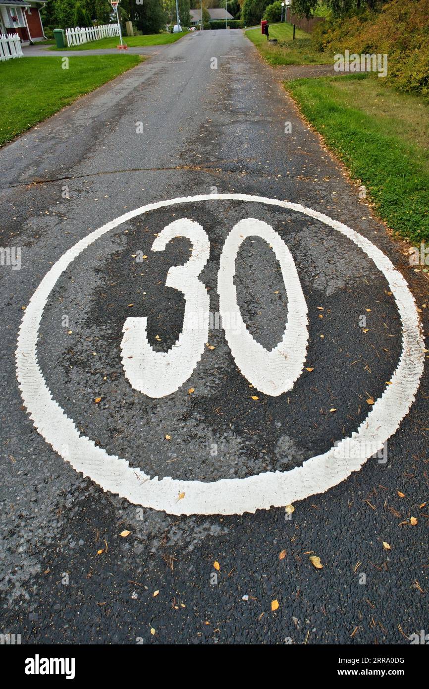 Speed limit sign of 30 painted on the ground Stock Photo - Alamy