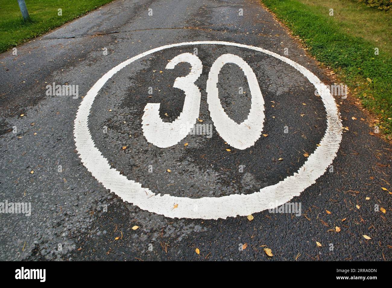 Speed limit sign of 30 painted on the ground Stock Photo - Alamy