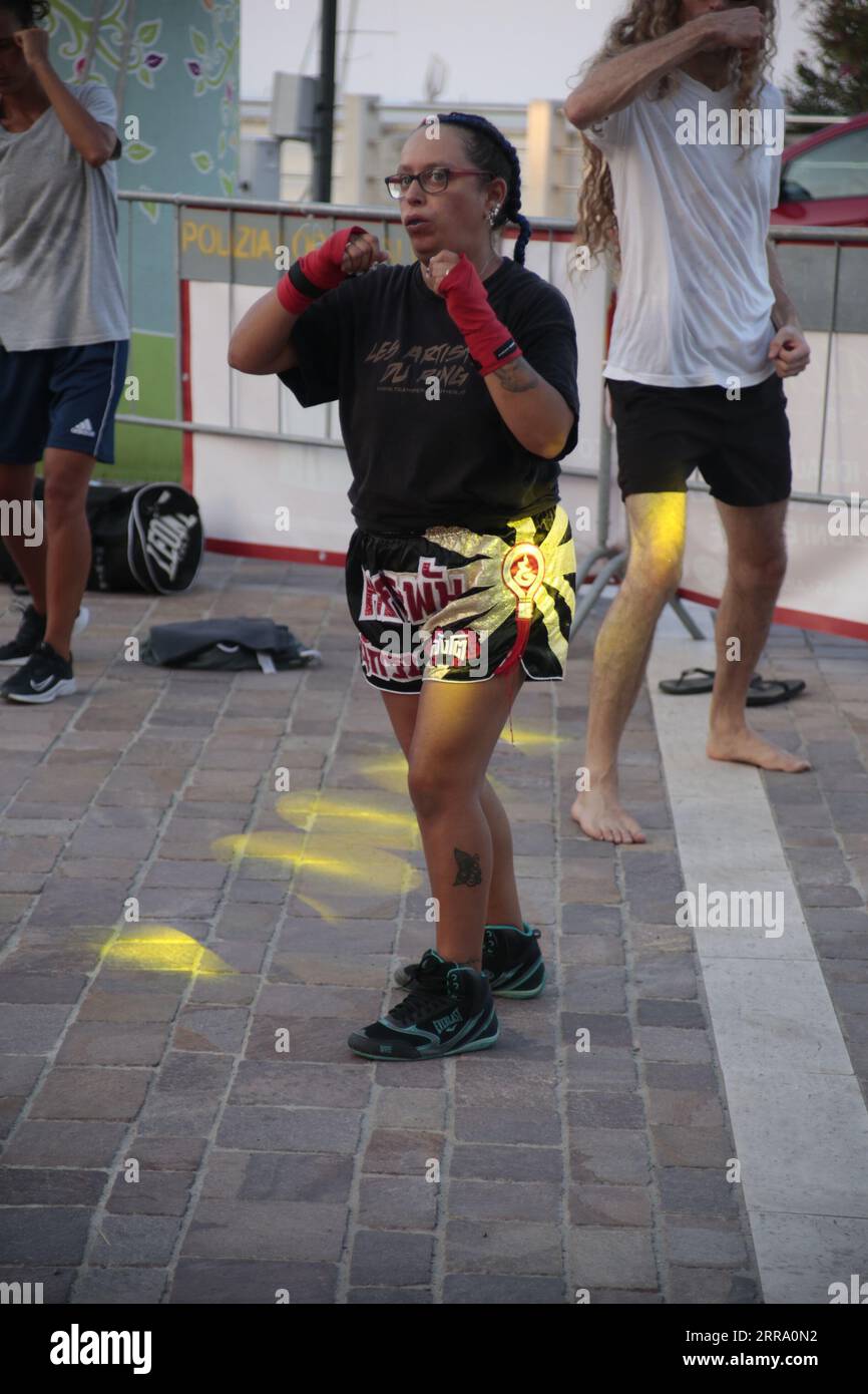 The images depict an animated children's kickboxing class in Italy at a ...