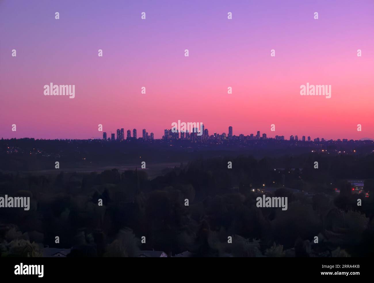 Urban cityscape on lilac sunset sky background Stock Photo - Alamy