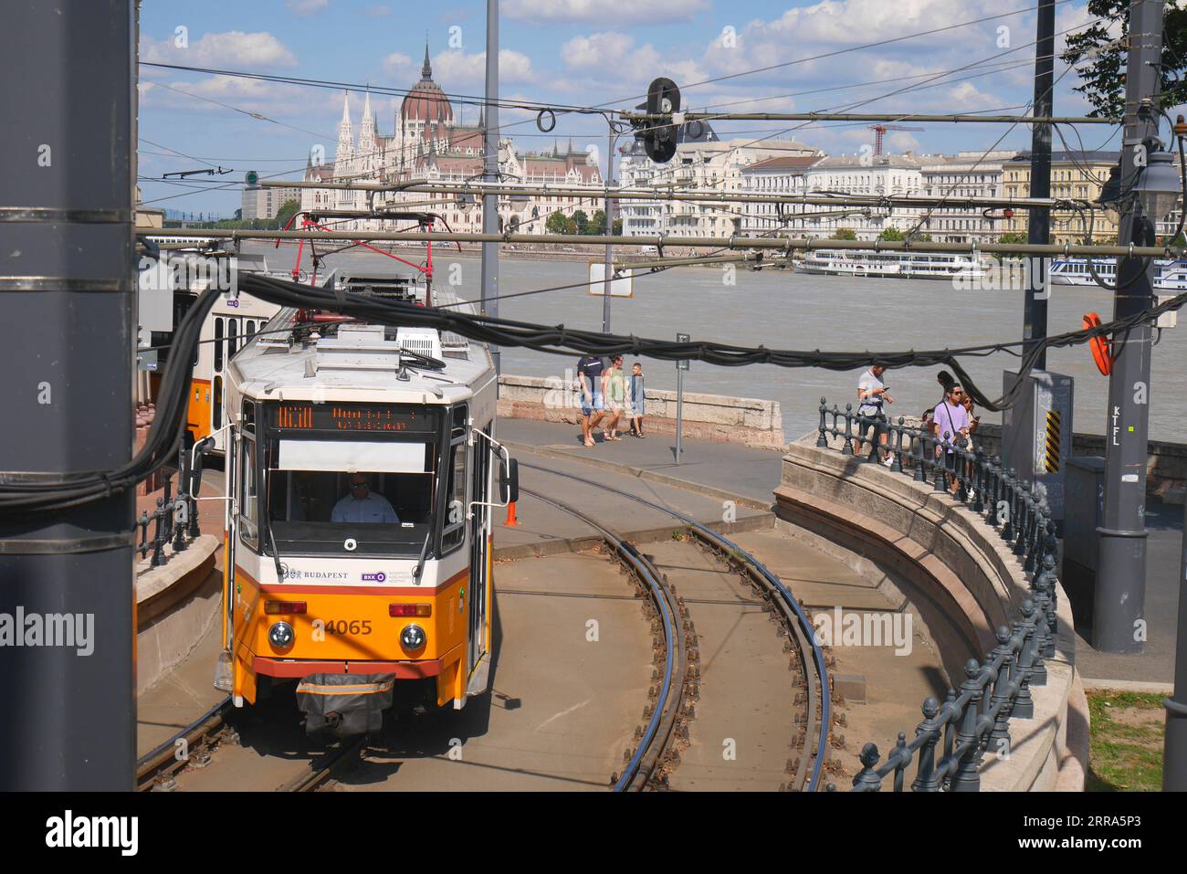 A tram on the Danube embankment with the parliament building across the ...