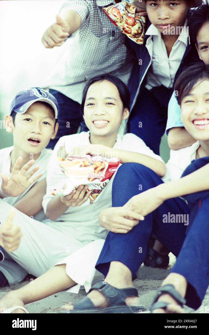 A group of young Vietnamese students happily posing for a group picture ...