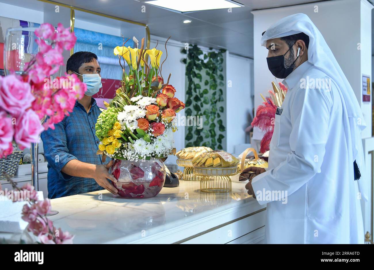 210718 -- DOHA, July 18, 2021 -- A Qatari man buys flowers at a shop ...