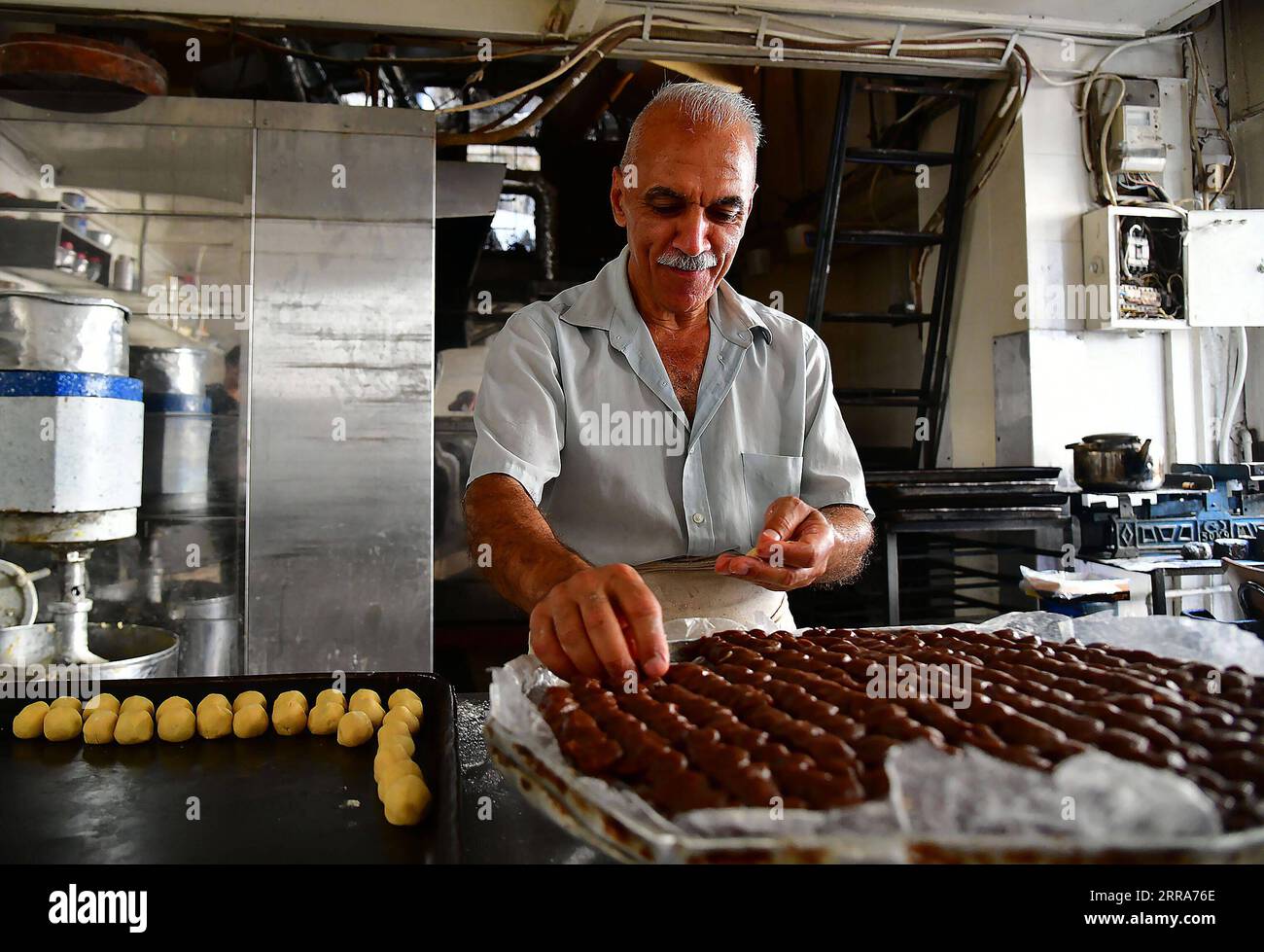 210719 -- DAMASCUS, July 19, 2021 -- A sweet maker arranges traditional ...