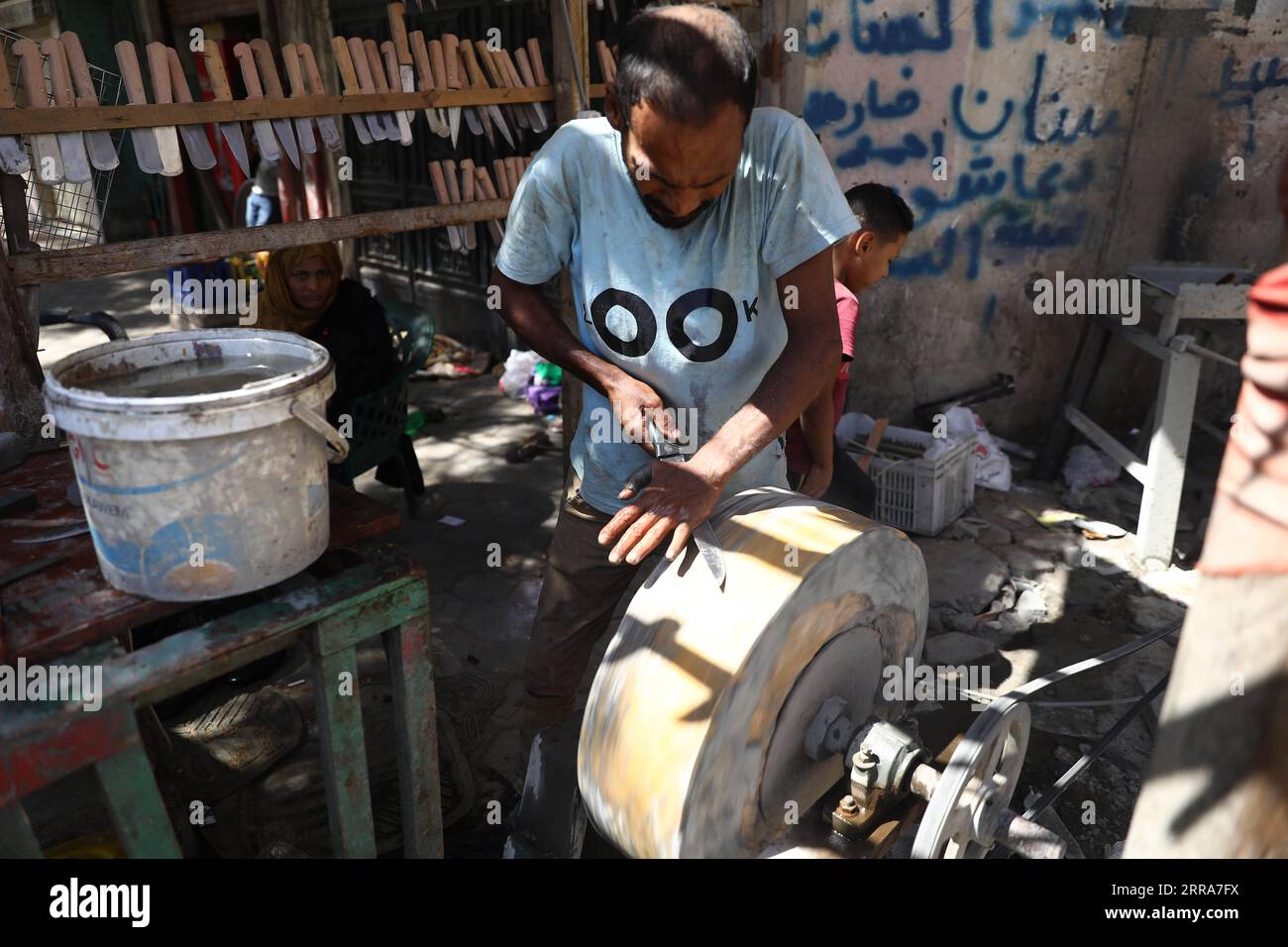 210719 -- CAIRO, July 19, 2021 -- A blacksmith sharpens a knife before ...