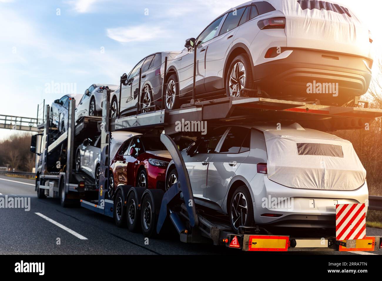 Tow truck car carrier semi trailer on highway carrying batch of new ...