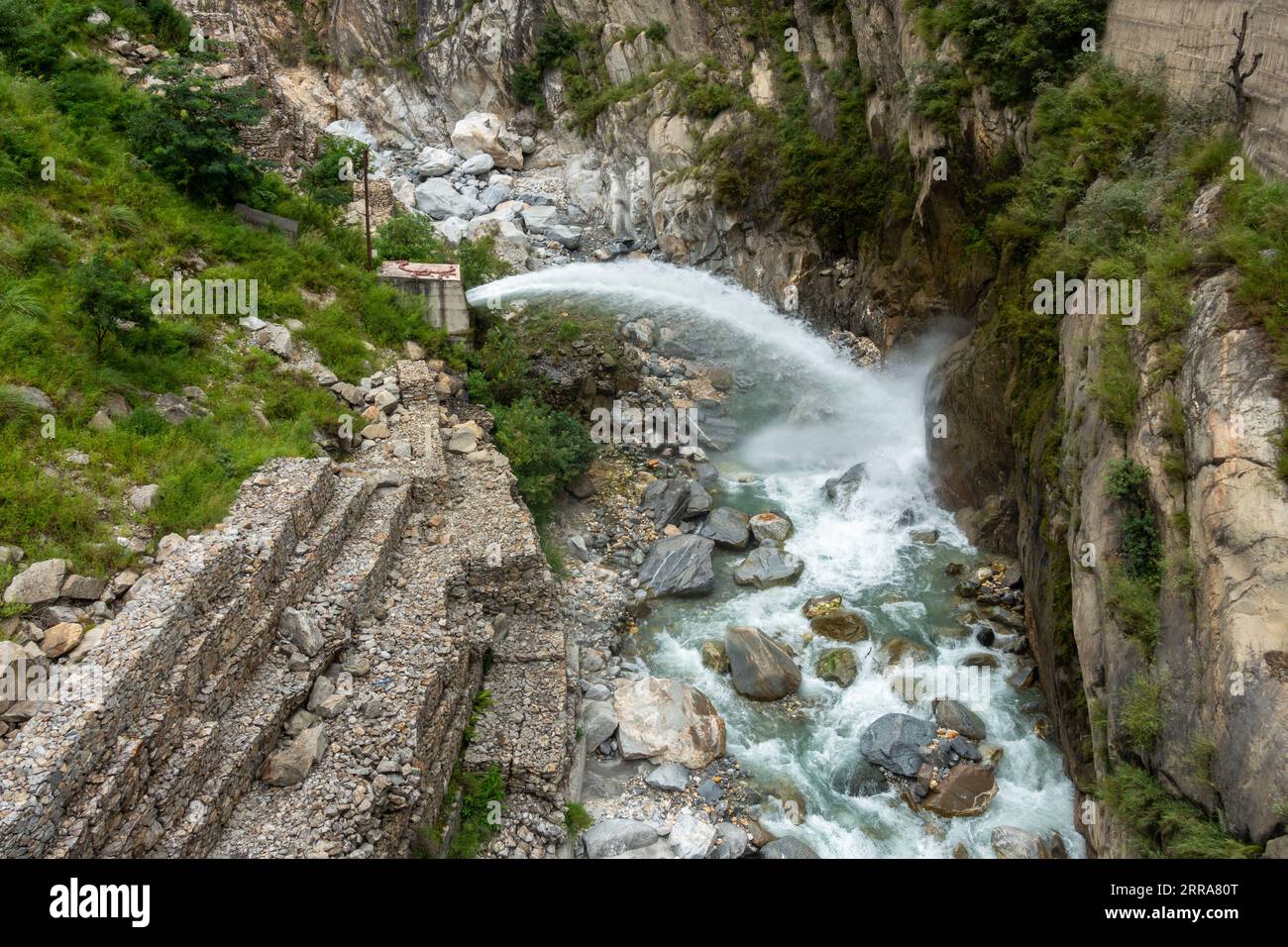 Emergency water outlet forcefully releasing into the river during the ...