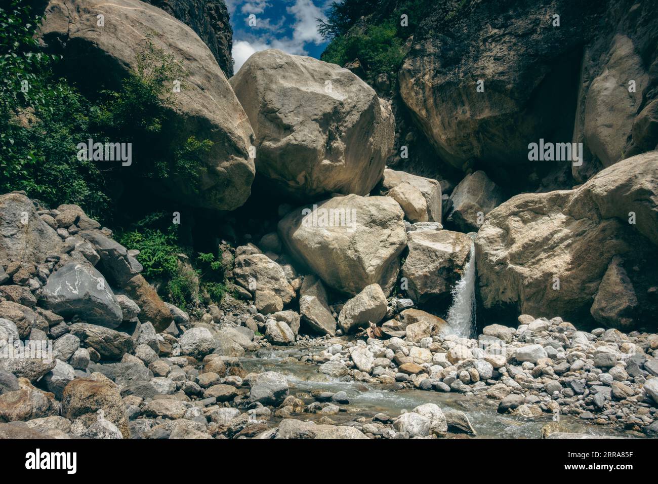 Scenic Himalayan waterfall amid massive rocks in Himachal Pradesh ...