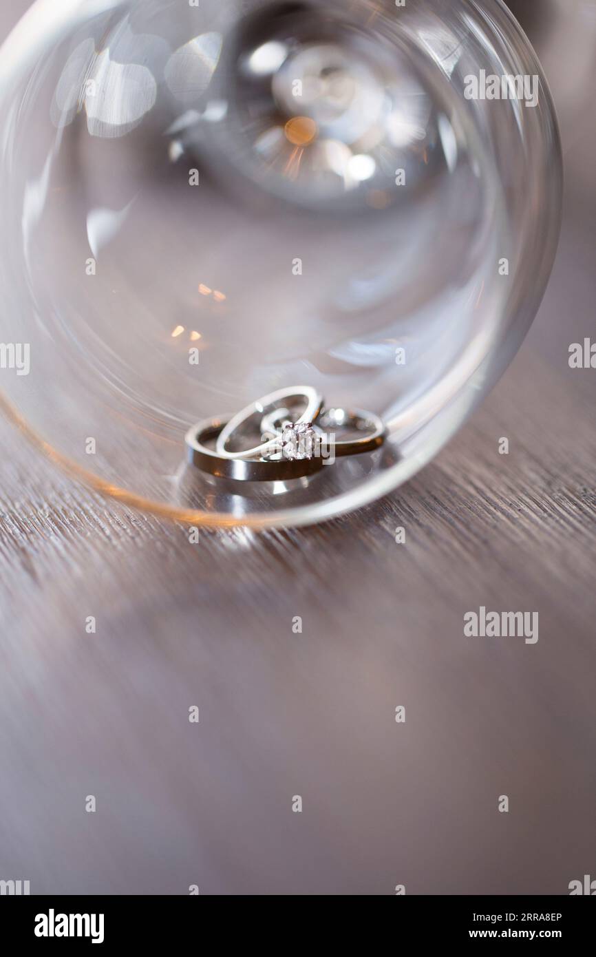 Close-up of Diamond Wedding Rings on Glossy Surface Stock Photo - Alamy