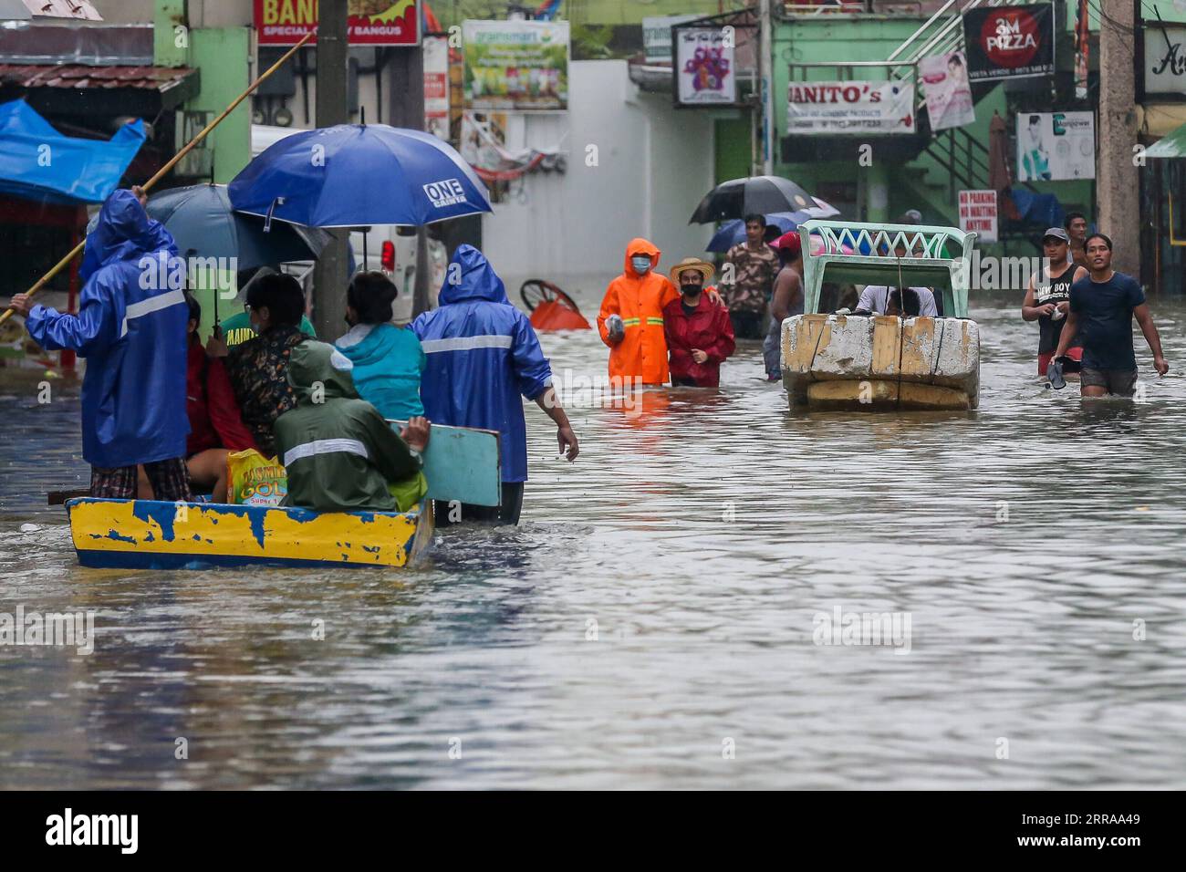210724 -- RIZAL PROVINCE, July 24, 2021 -- People wade through the ...