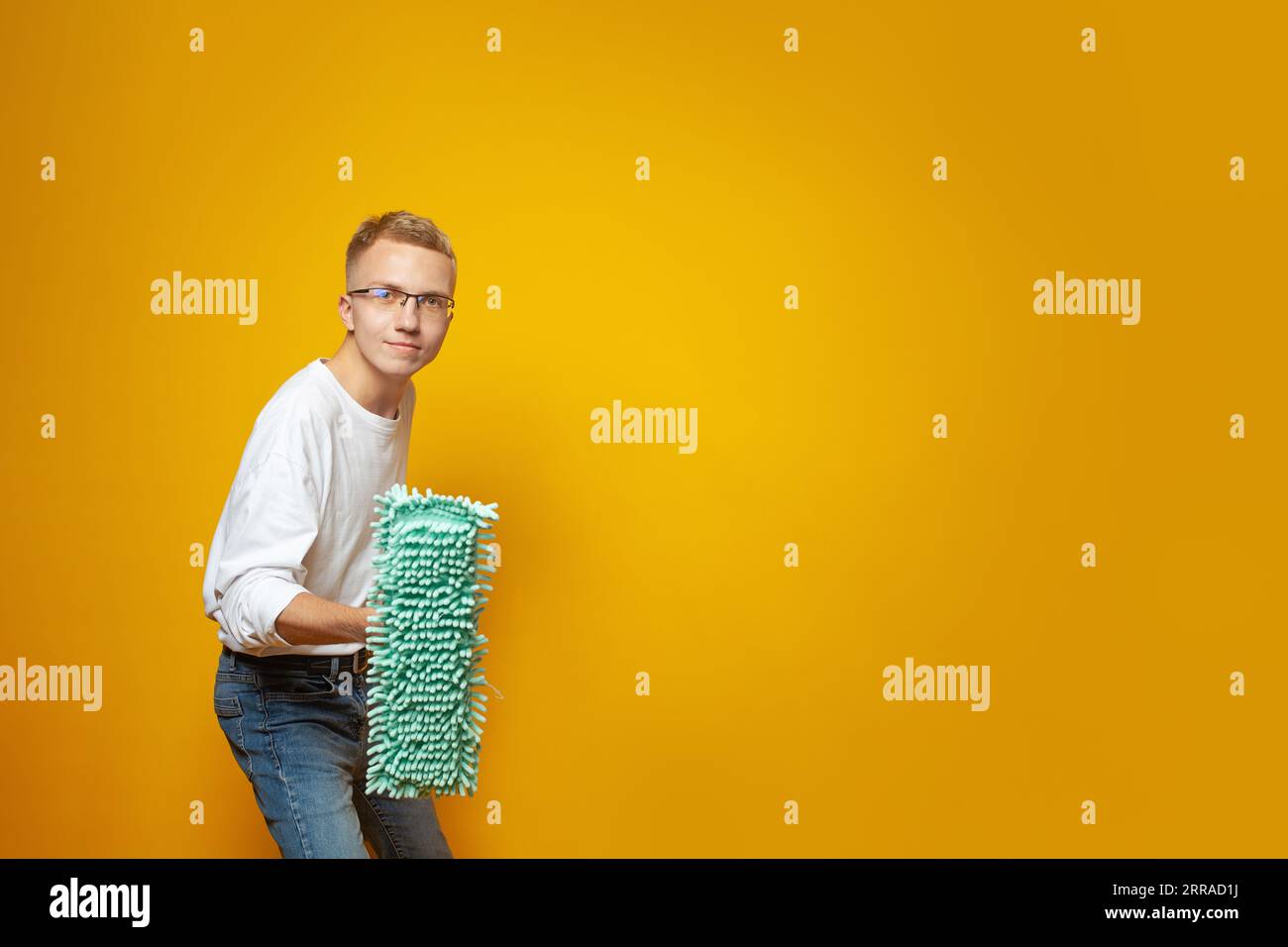 Cleaning man. Happy man with mop on bright orange background Stock ...
