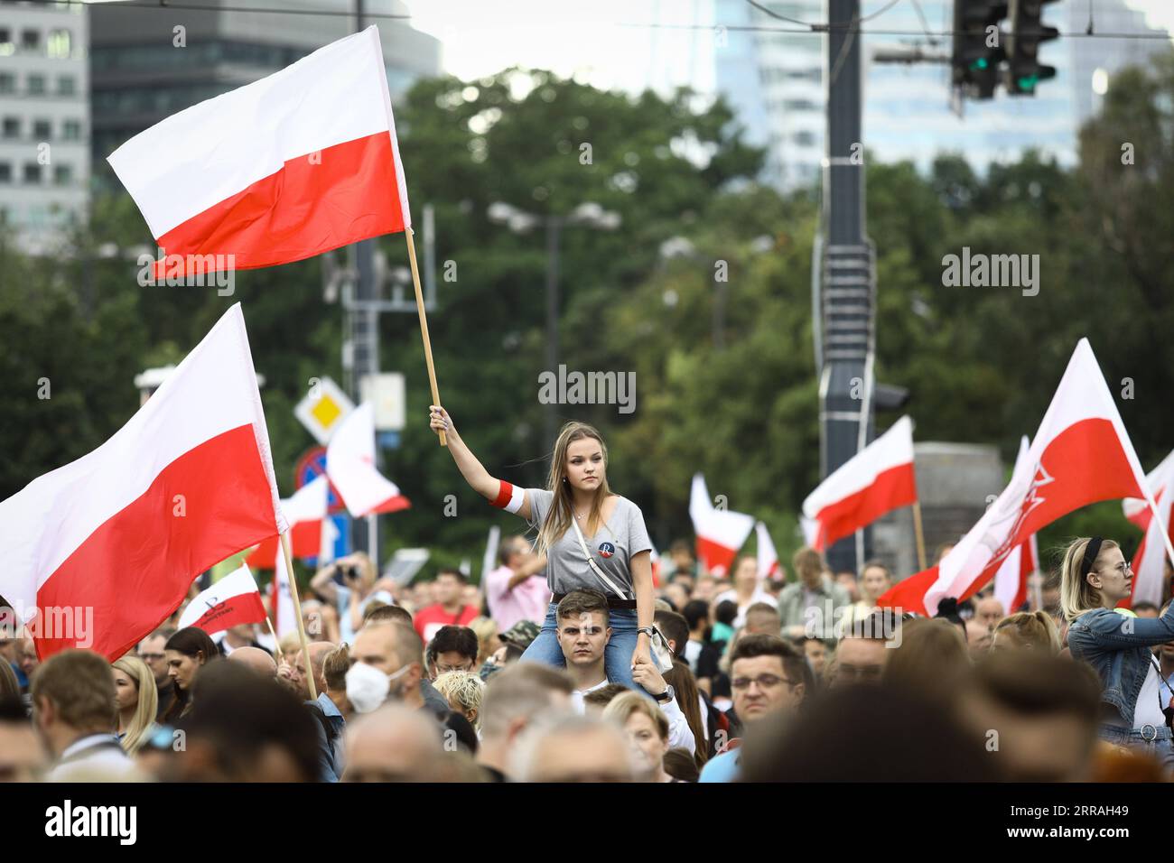 210801 -- WARSAW, Aug. 1, 2021 -- A girl holds a Polish national flag ...